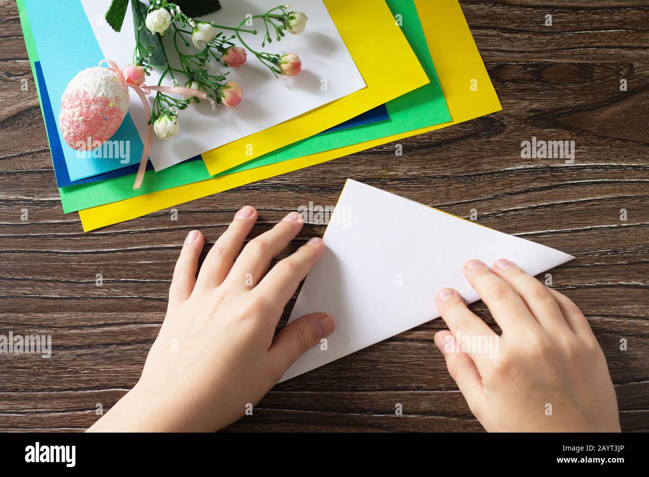 Origami instruction, step 2. The child fold the origami Easter chick ...