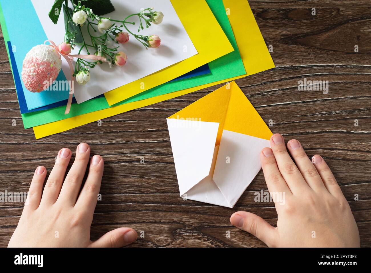 Origami instruction, step 5. The child fold the origami Easter chick ...