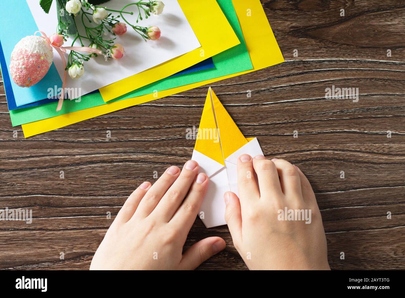 Origami instruction, step 8. The child fold the origami Easter chick ...