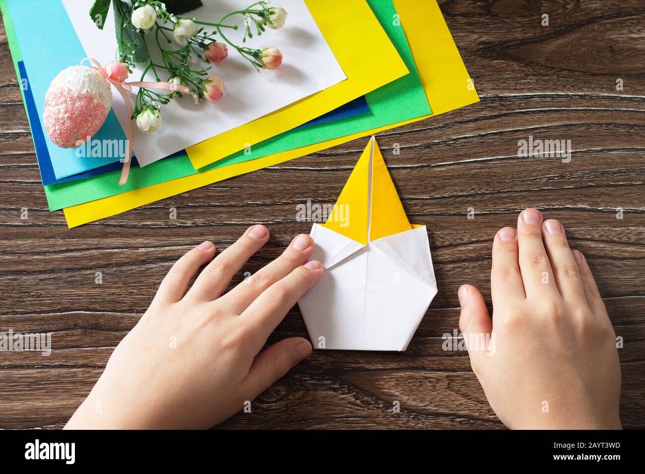 Origami instruction, step 9. The child fold the origami Easter chick ...