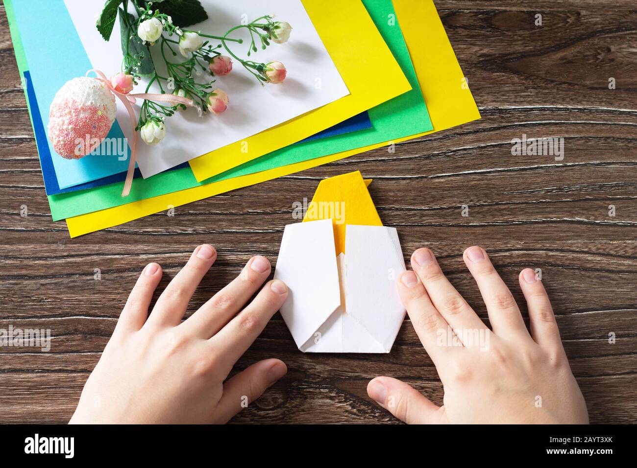 Origami instruction, step 11. The child fold the origami Easter chick ...