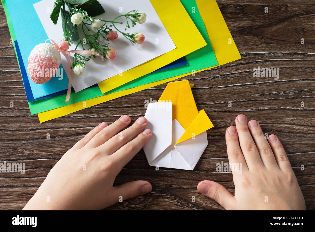 Origami instruction, step 12. The child fold the origami Easter chick ...