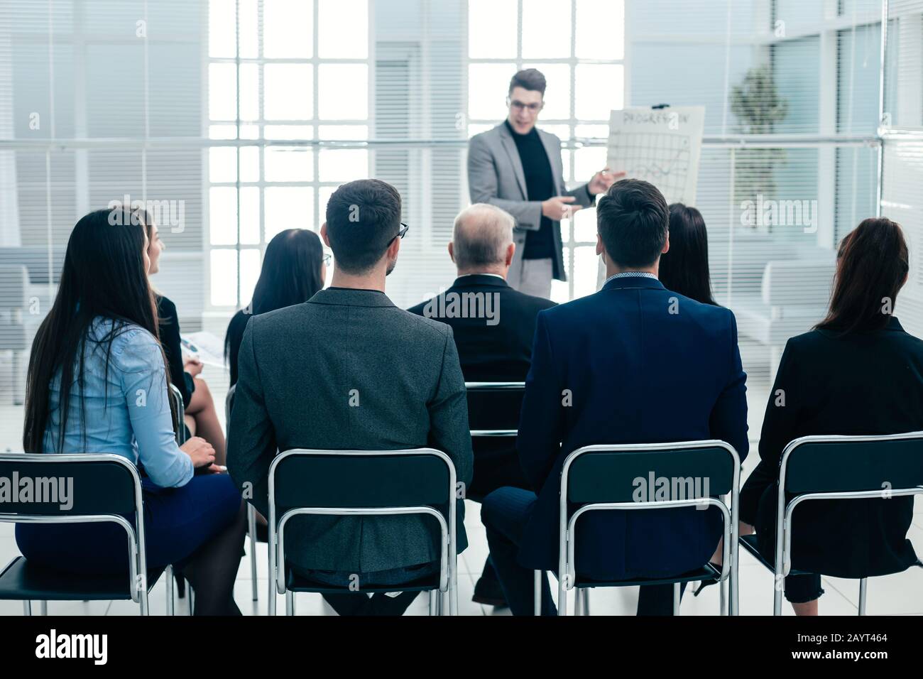 rear view. The audience listens to the lecturer in the conference room ...