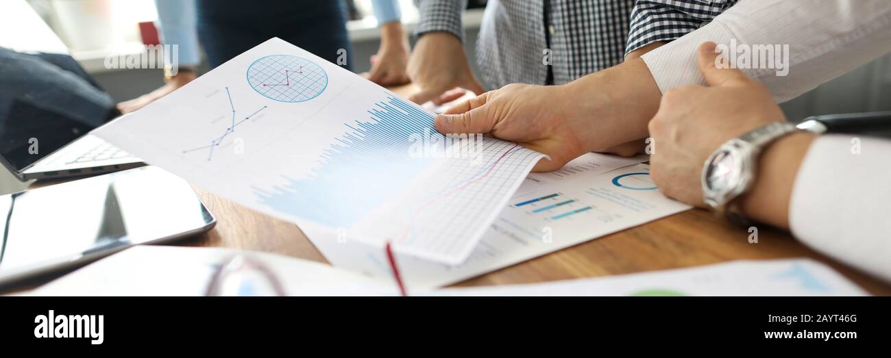 Manager holding in hand financial graph paper Stock Photo - Alamy