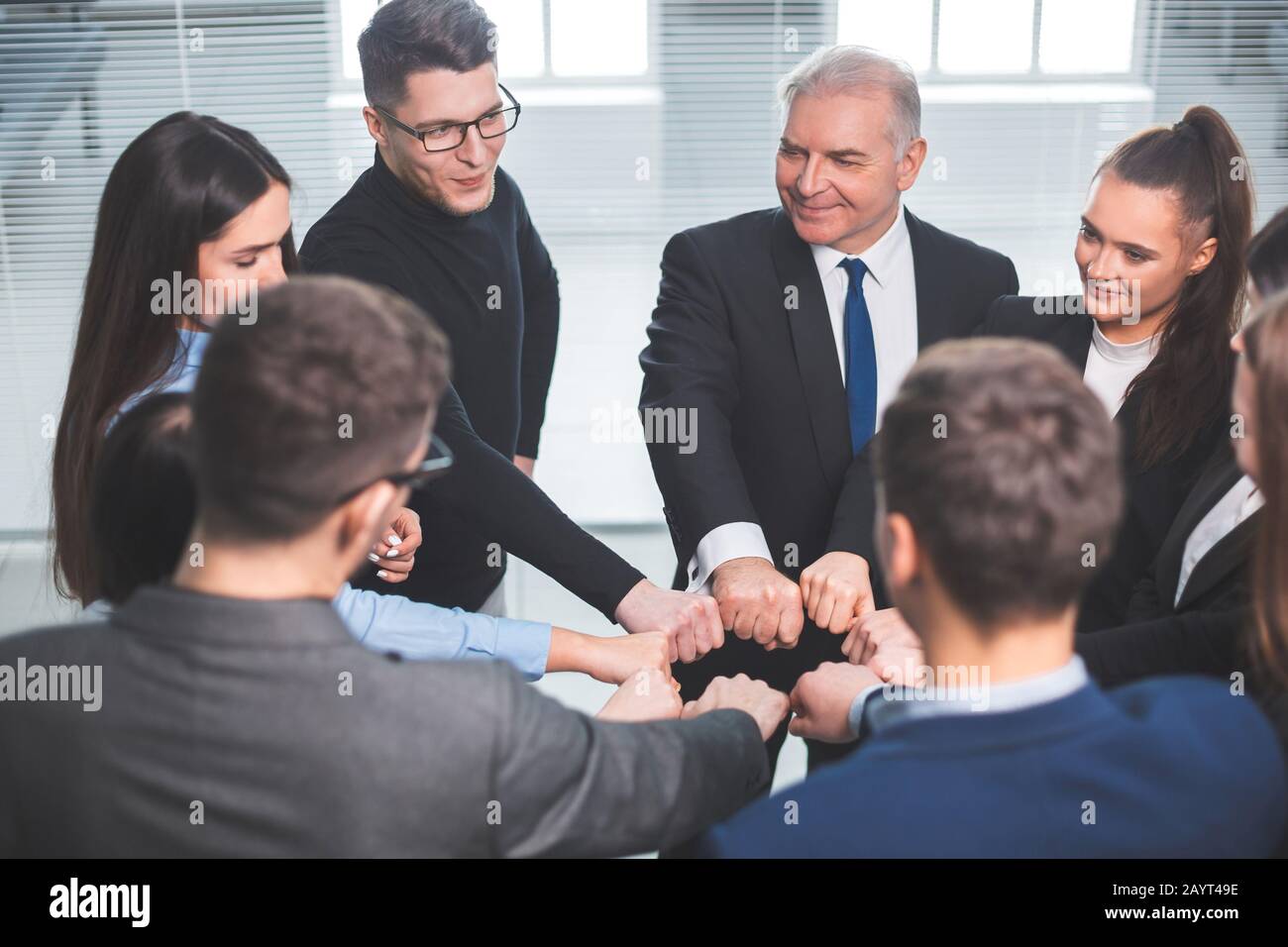 close up. a team of young professionals standing in a circle. the ...