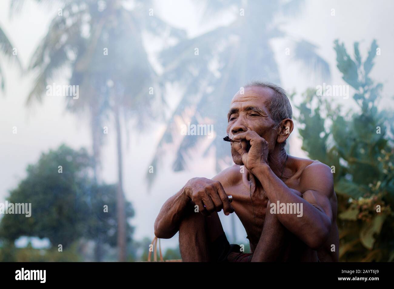 Older Asian men are sitting smoking in the countryside Stock Photo - Alamy