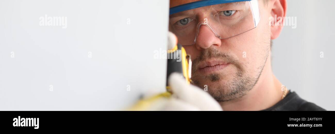 Engineer measuring wall size Stock Photo - Alamy