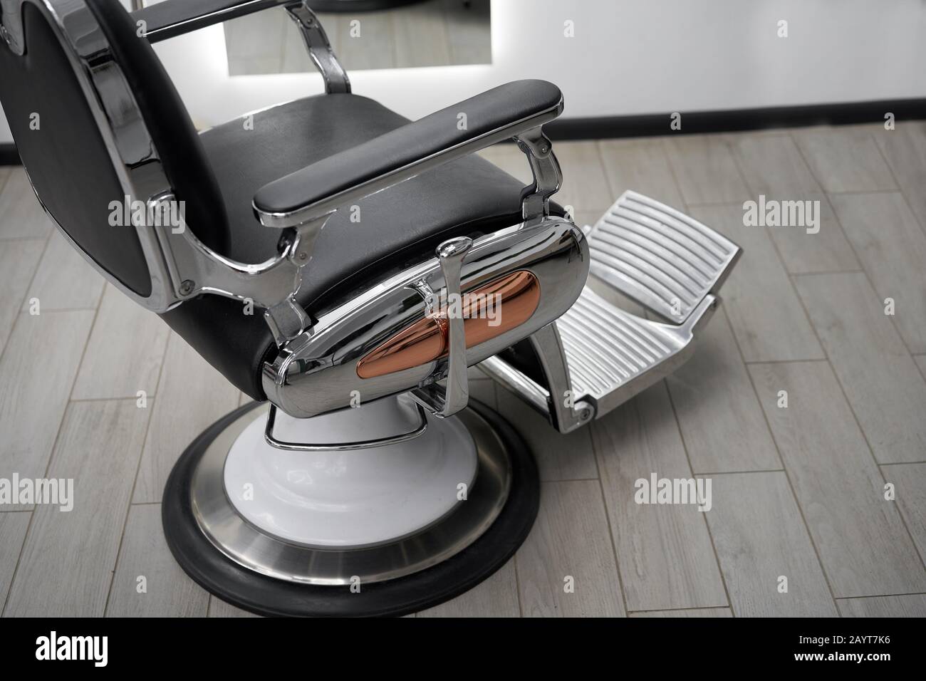 Classic vintage barber chair stands opposite mirror stylish white ...