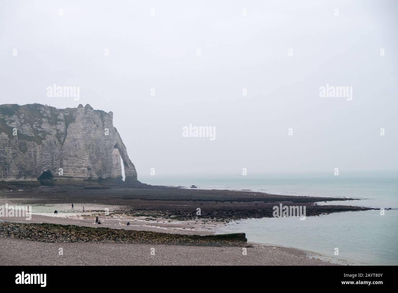 Misty morning landscape of the Natural white chalk cliffs in Etretat ...
