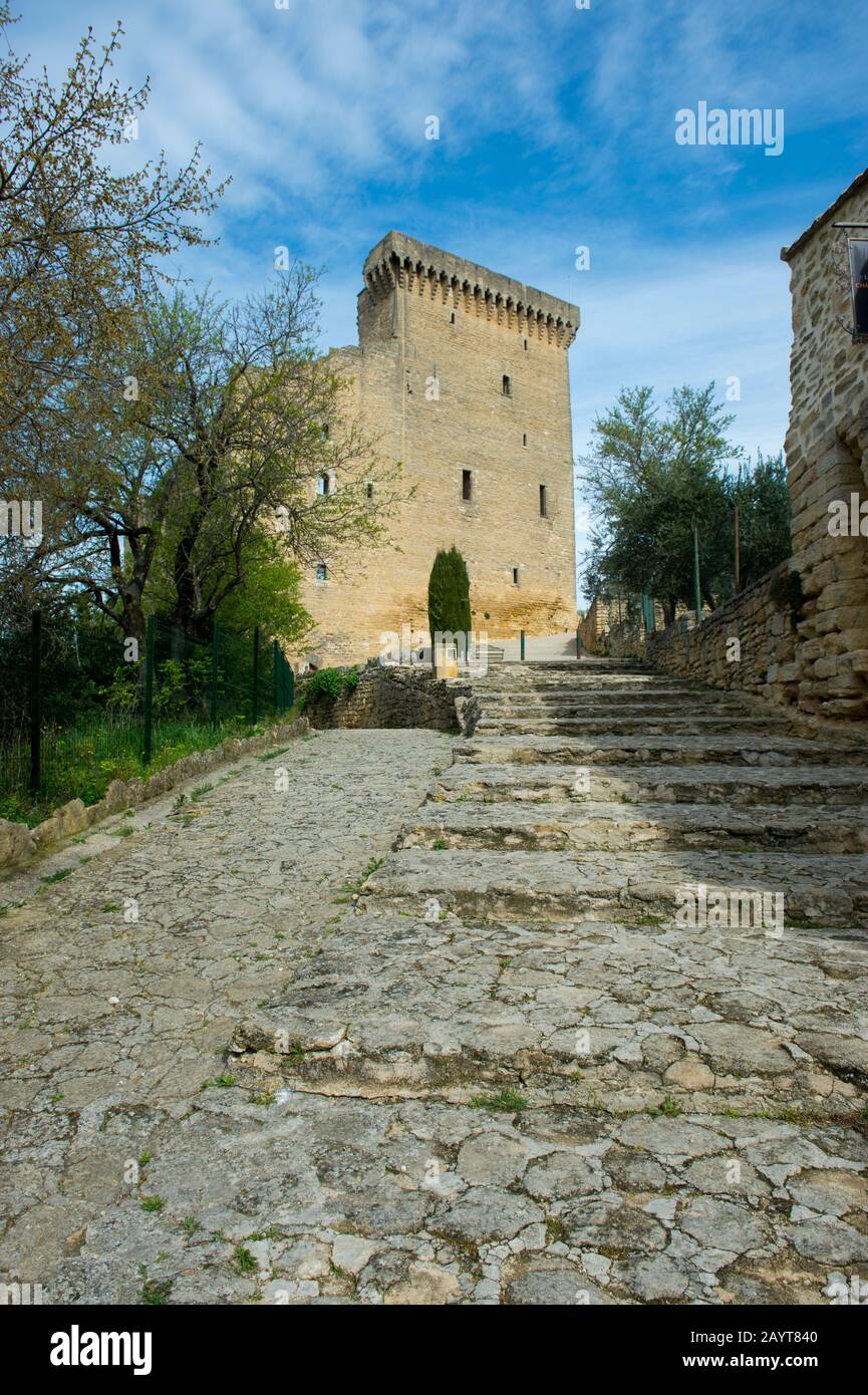 The ruins of a mediaeval castle on top of a hill above the village of ...