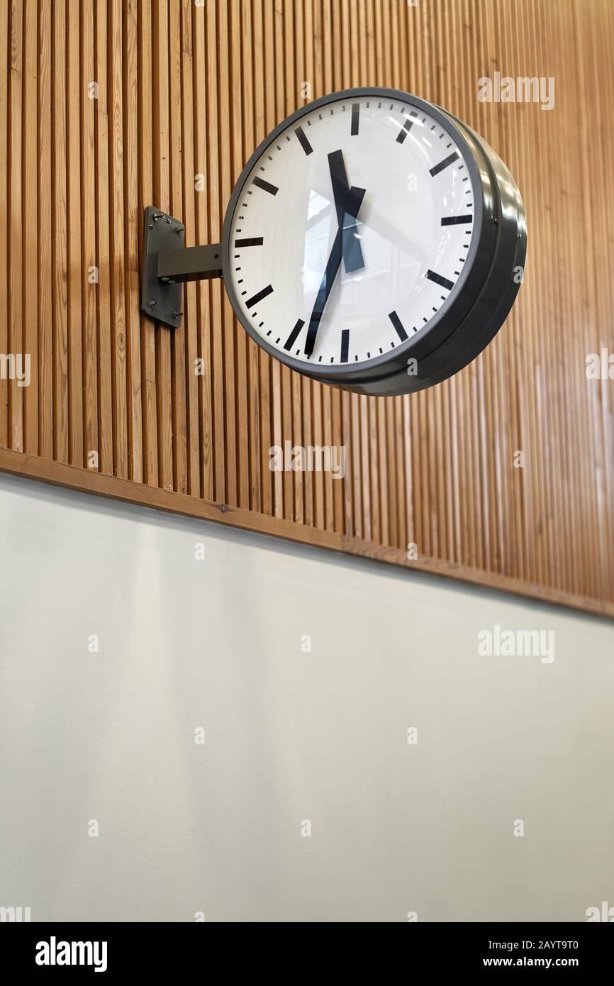 Dark hallway clock hanging on wooden wall Stock Photo - Alamy