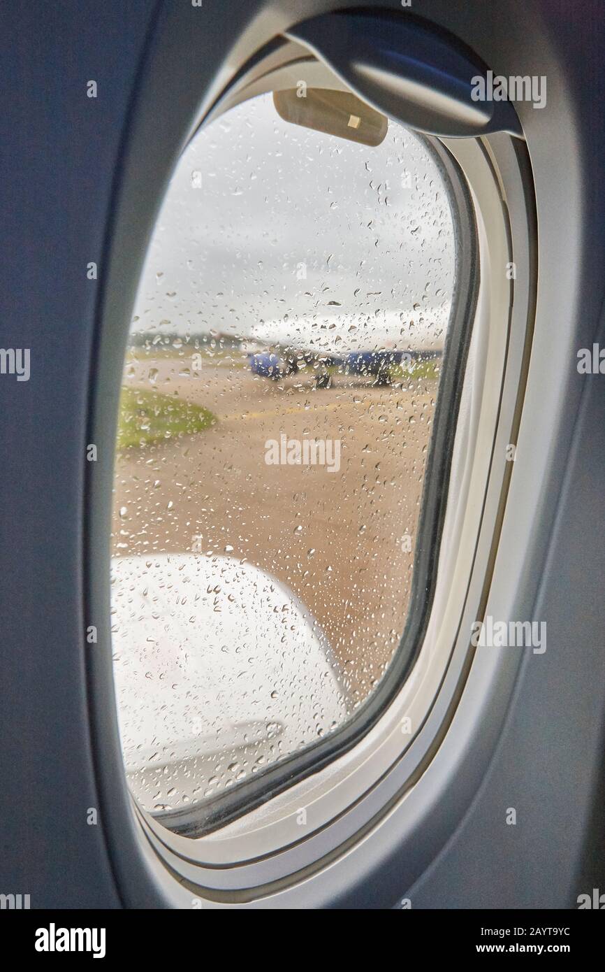 Open window with raindrops on a comercial aeroplane. Cabin interior ...