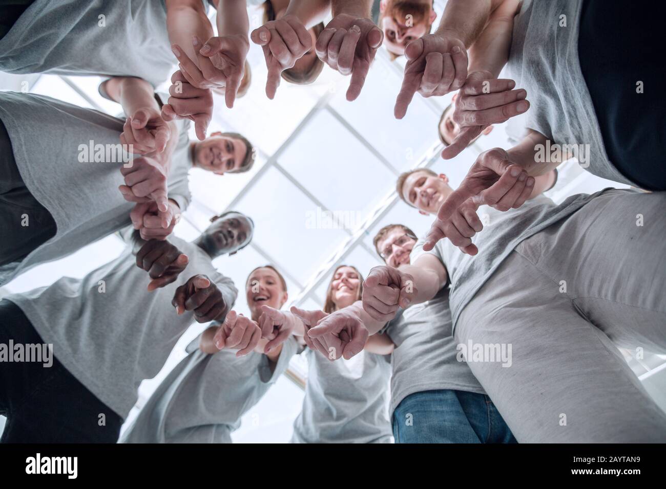 group of successful young people pointing at a target Stock Photo - Alamy