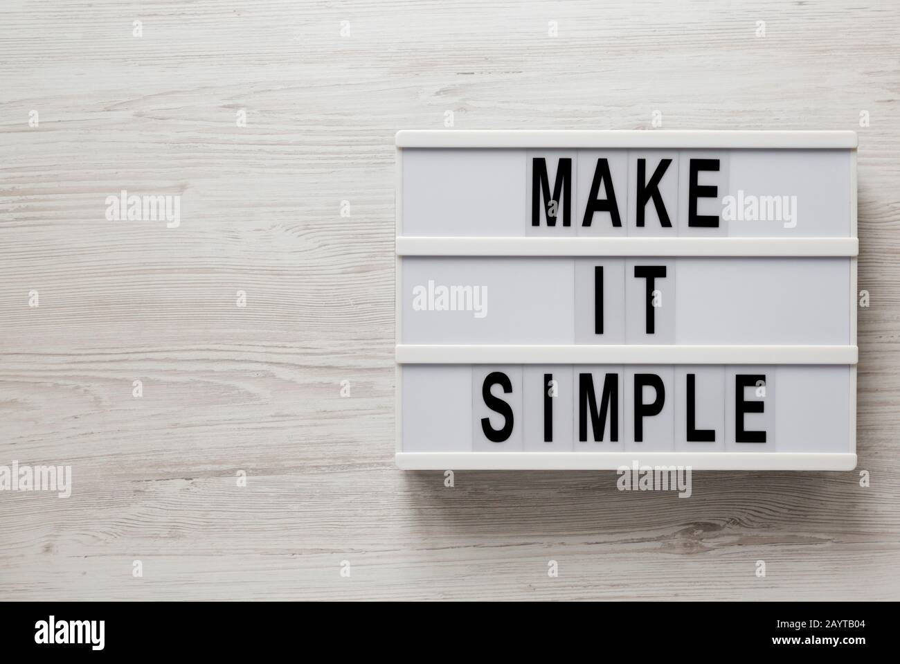 'Make it simple' words on a modern board on a white wooden background ...