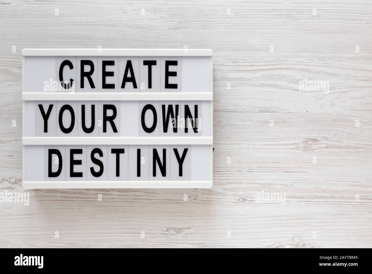 'Create your own destiny' words on a lightbox on a white wooden ...