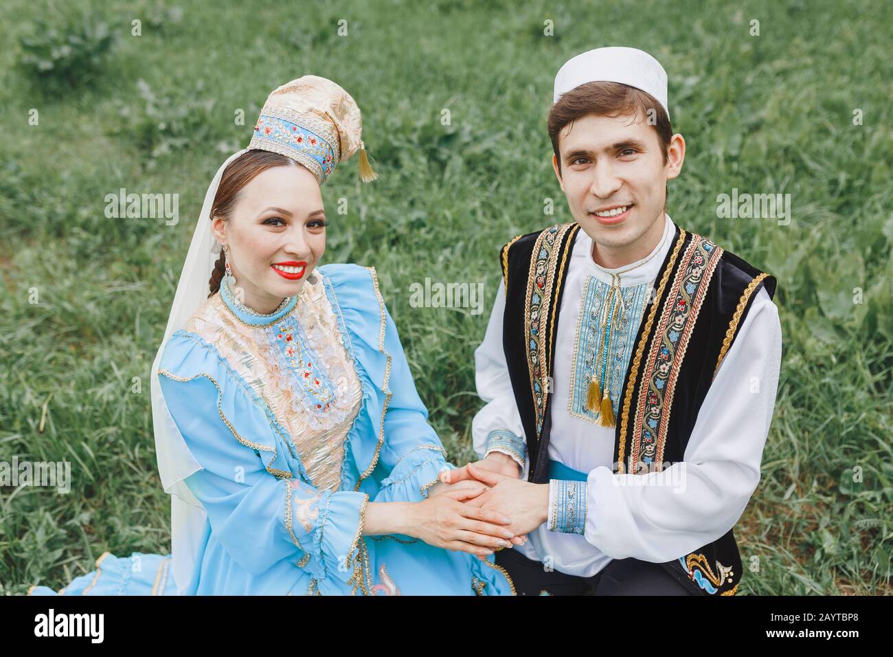 A man and a woman in traditional embroidered clothes celebrate the ...