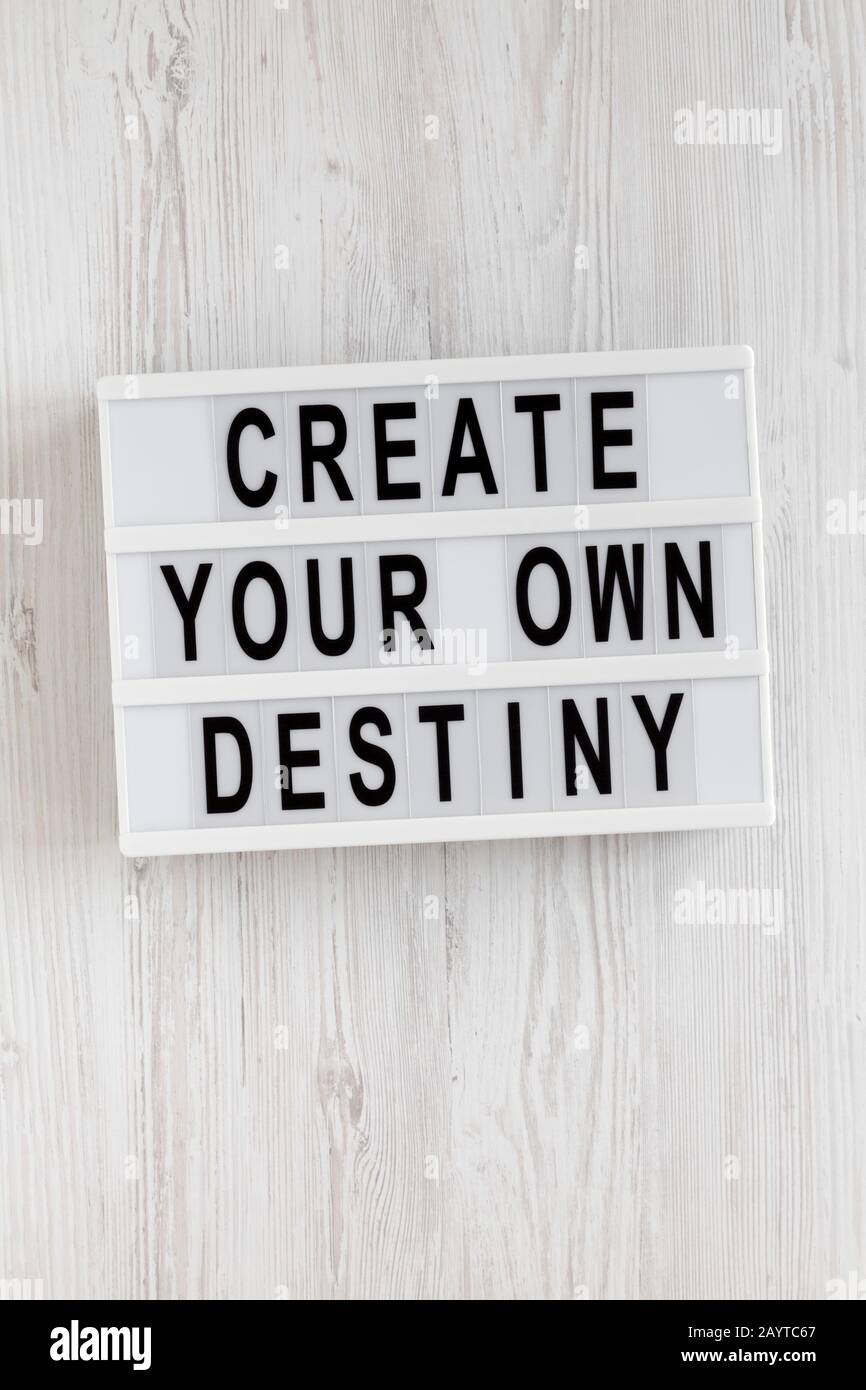 'Create your own destiny' words on a lightbox on a white wooden ...