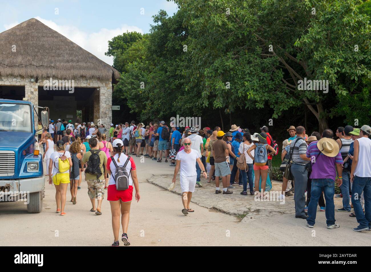 A long line of tourists at the ticket counter at Tulum, which is the ...