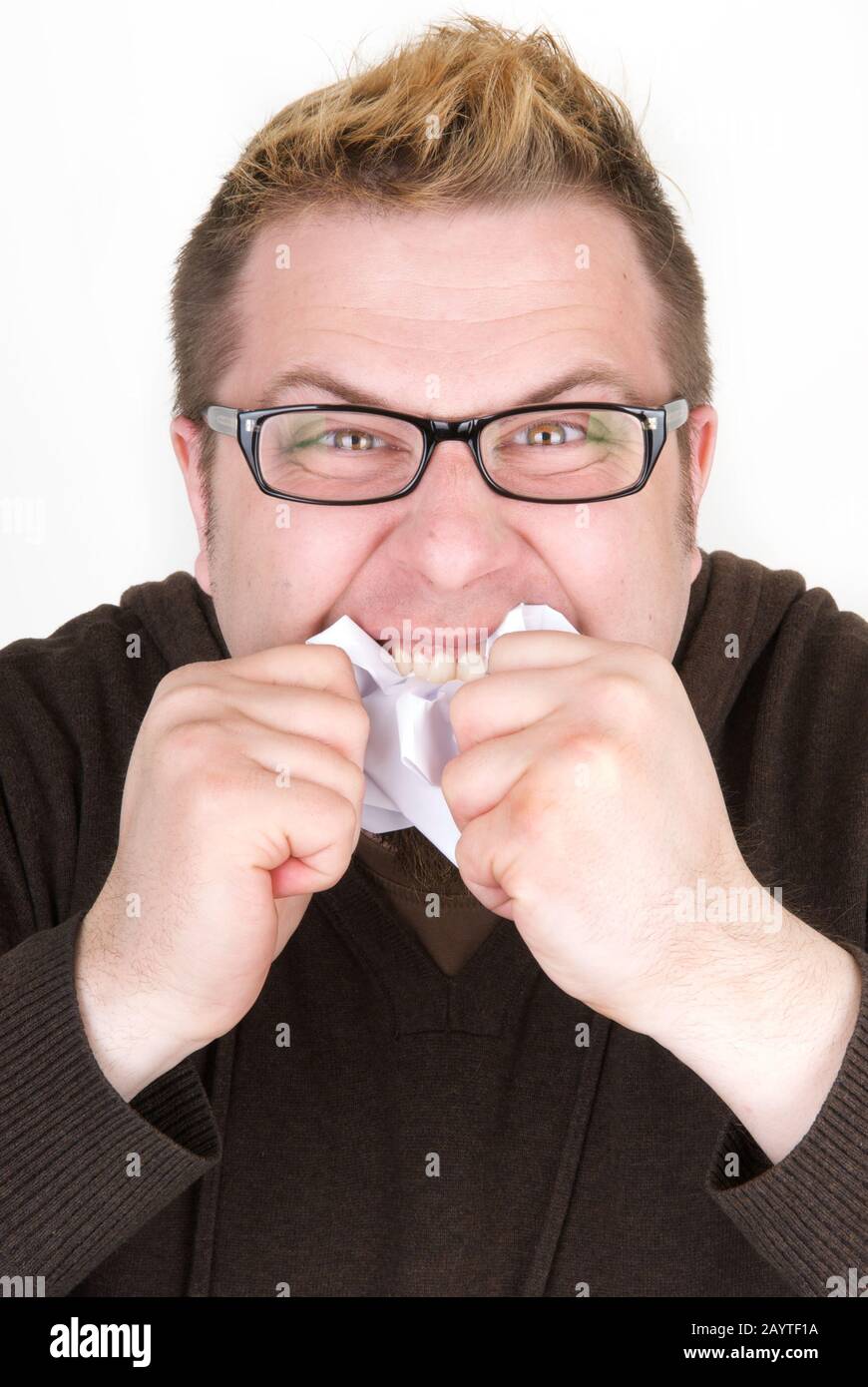Shocked man eating a document Stock Photo - Alamy