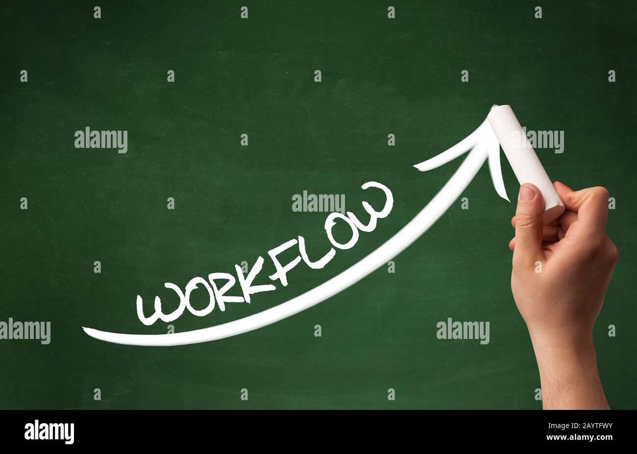 Hand drawing WORKFLOW inscription with white chalk on blackboard ...