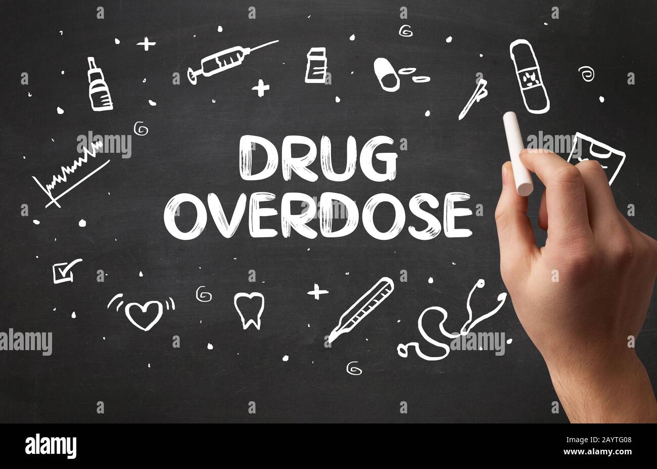 Hand drawing DRUG OVERDOSE inscription with white chalk on blackboard ...