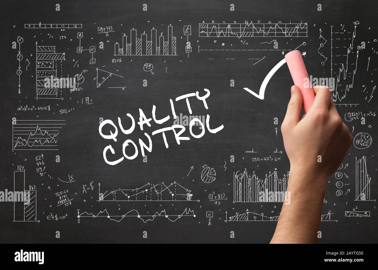 Hand drawing QUALITY CONTROL inscription with white chalk on blackboard ...