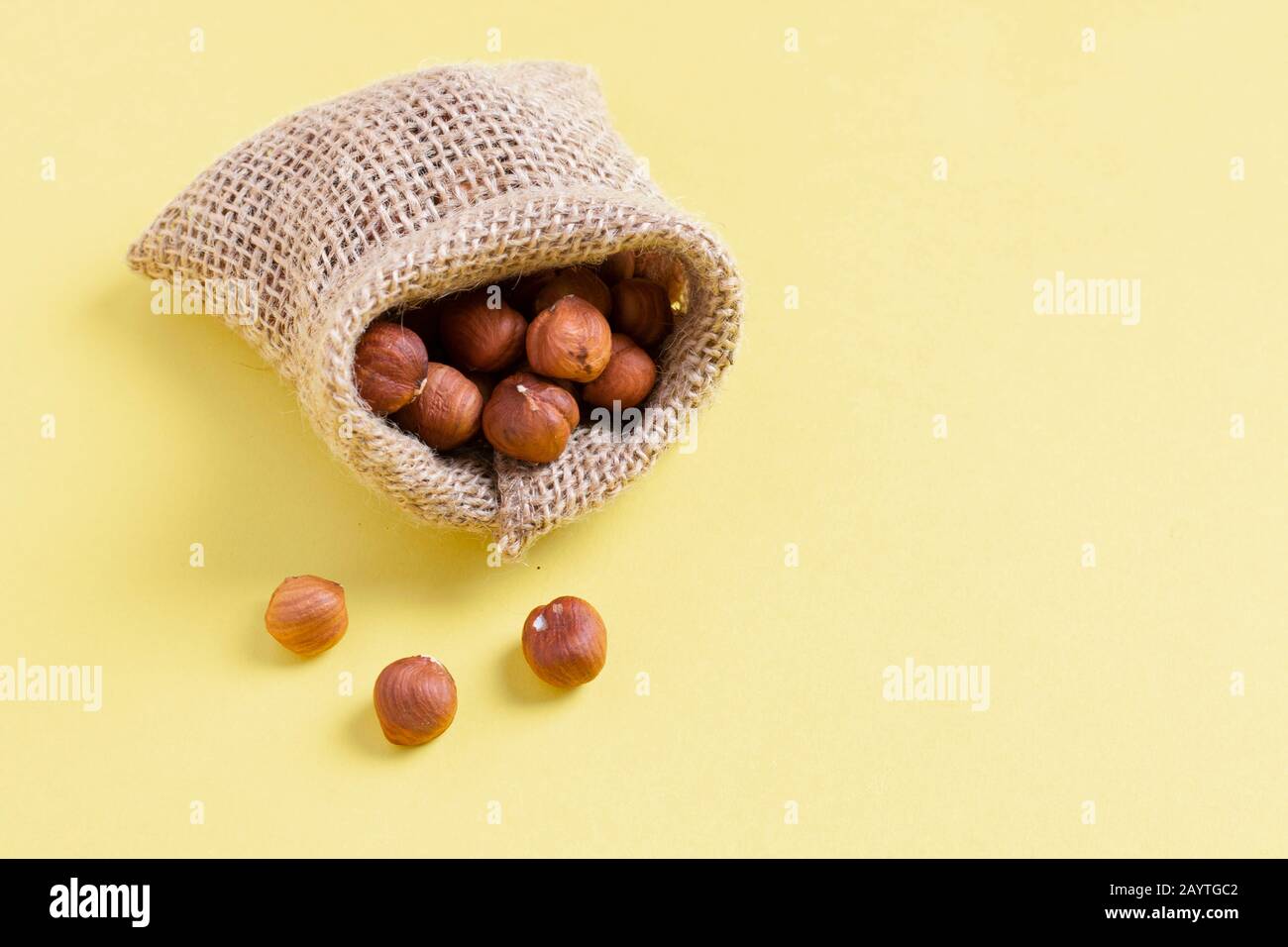 Hazelnuts, filbert in burlap sack on wooden backdrop. heap or stack of ...