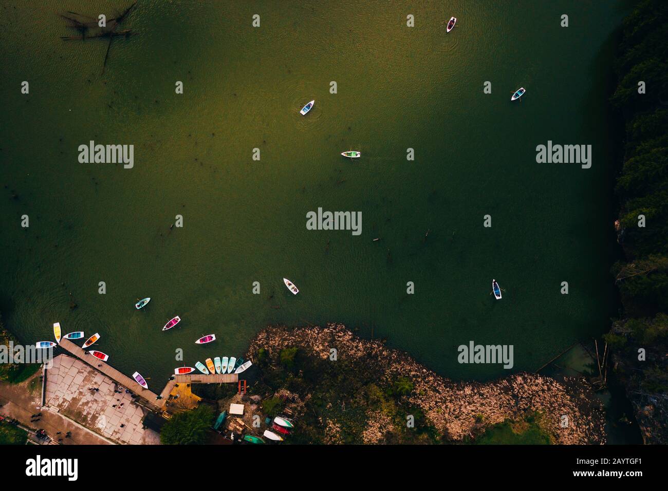 Lake ina pine tree forest with small boats seen from a drone Stock ...