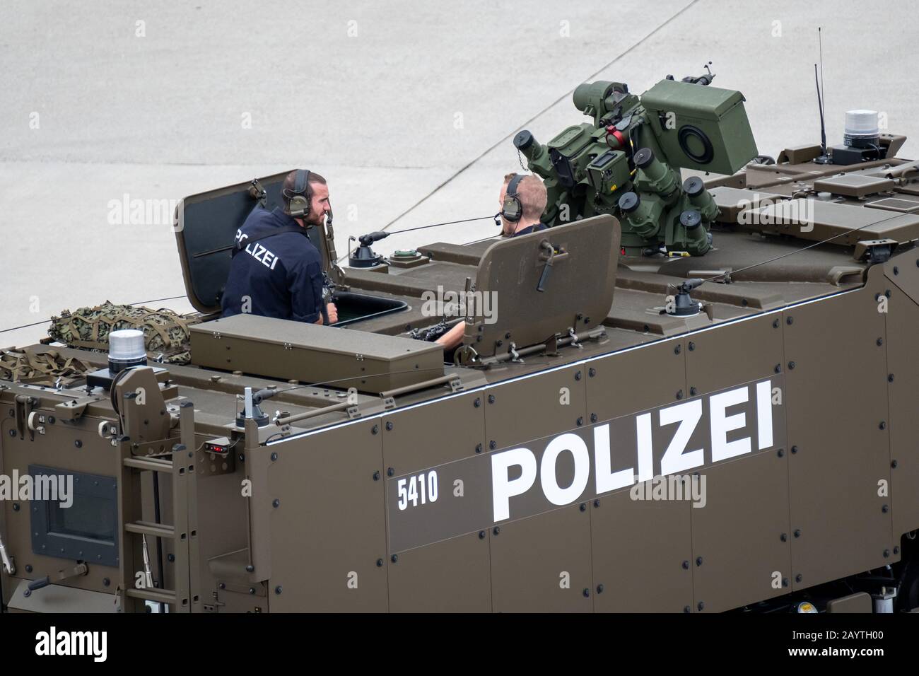 Police on an armored car guarding a private jet Stock Photo - Alamy
