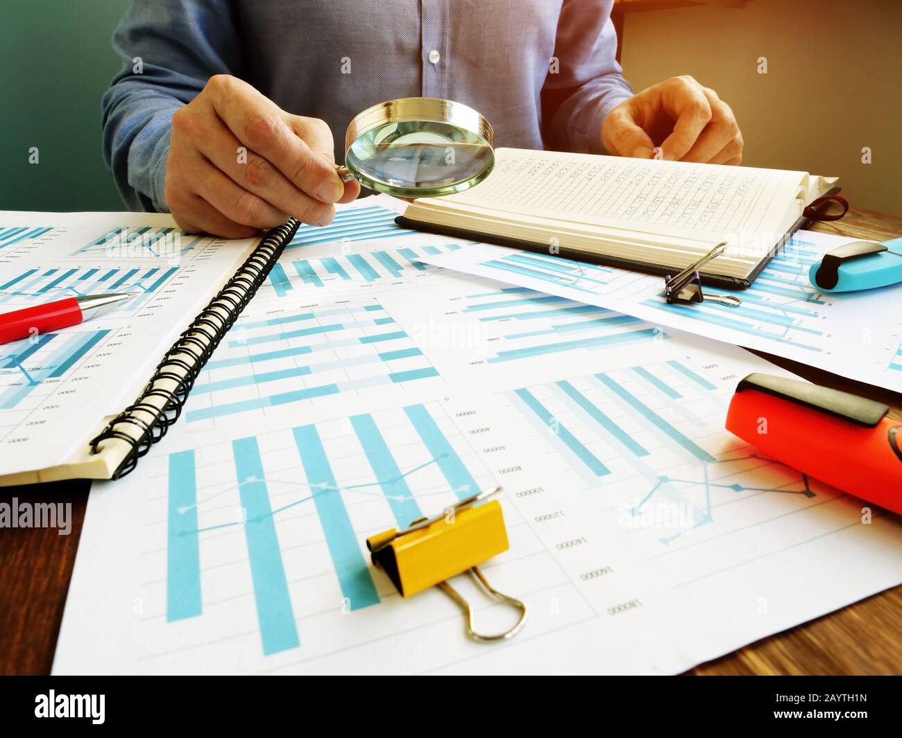 Auditor makes financial company audit and uses magnifying glass for ...