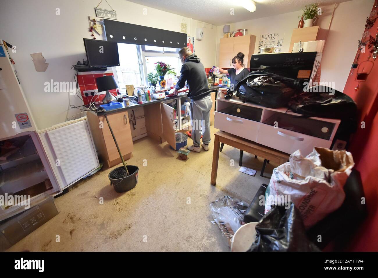 Lee Griffiths and Michelle Jones emptying out cupboards after flooding ...