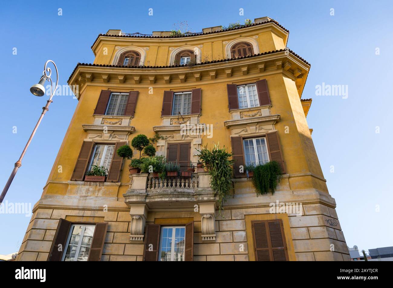 Old historic residential building with green plants on the balcony ...