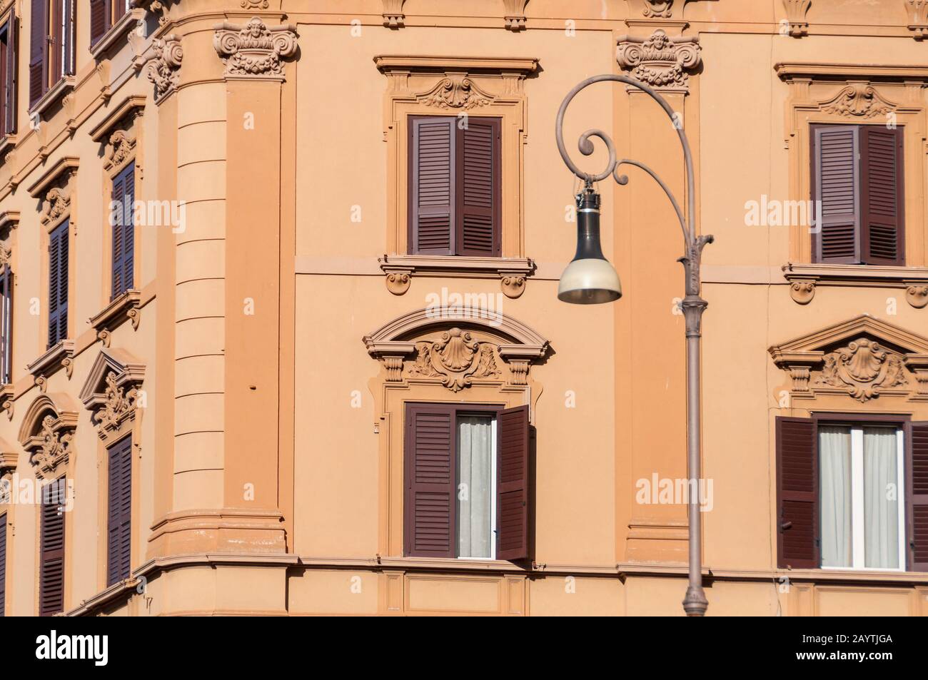 Close up of historic building with decorated window frames and street ...