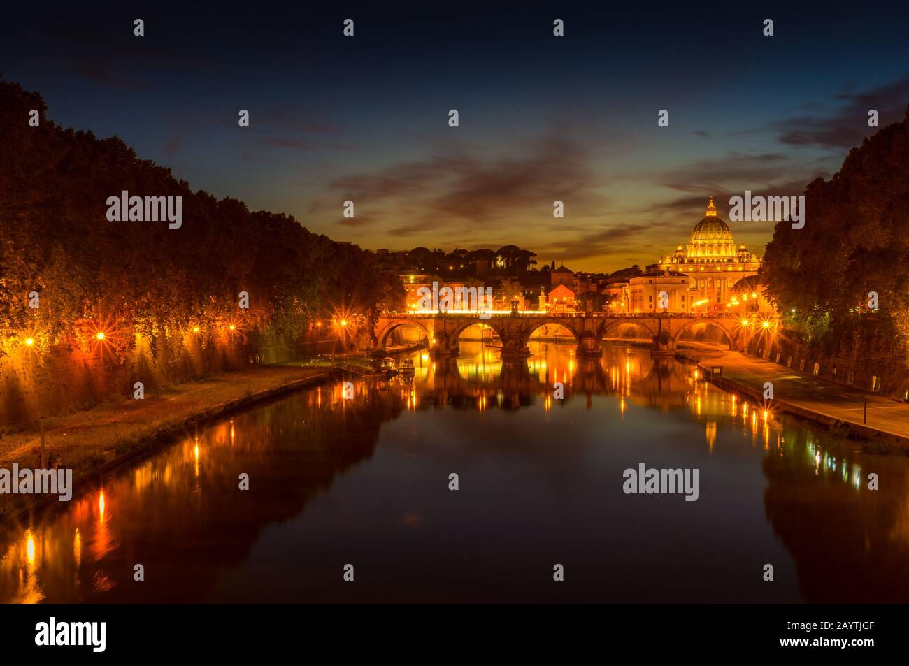 Rome cityscape at night with illuminated arch bridge and St Peters ...