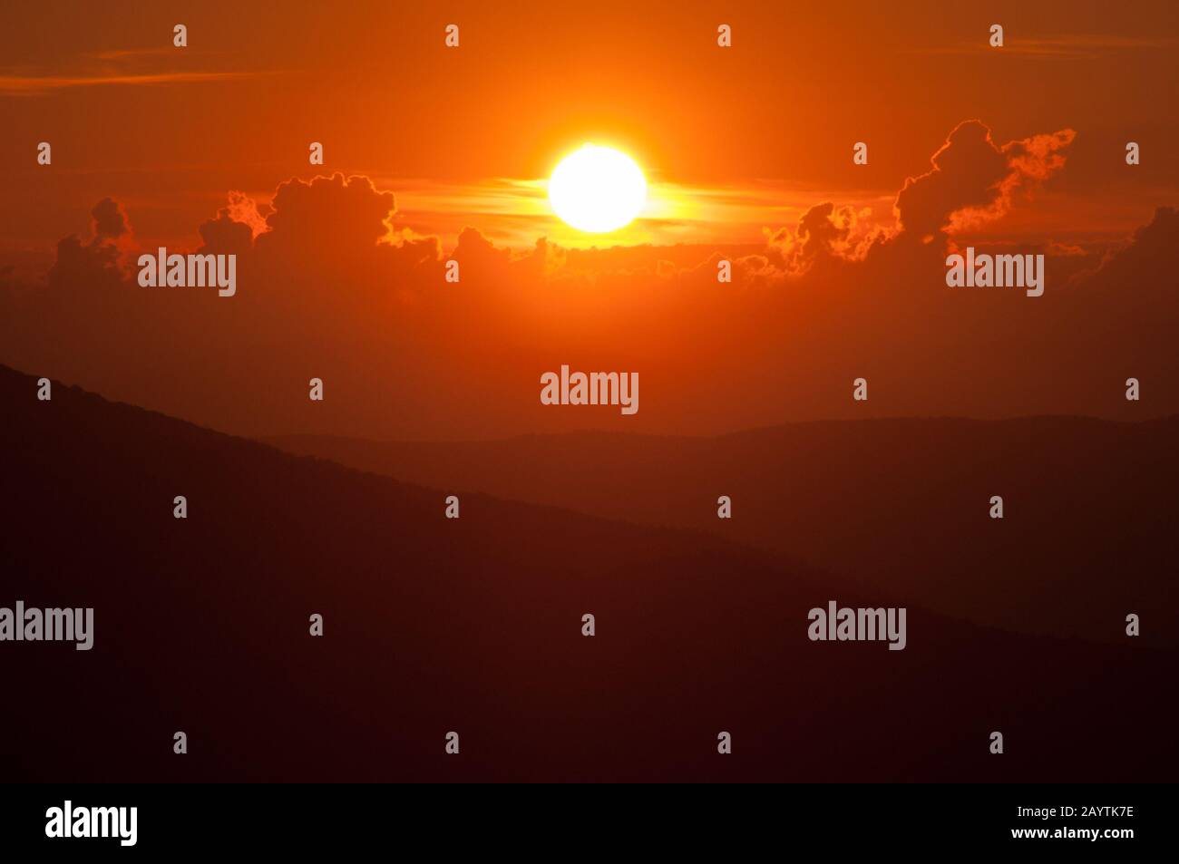 Epic sunset landscape with vibrant orange sky and hills. Summer ...