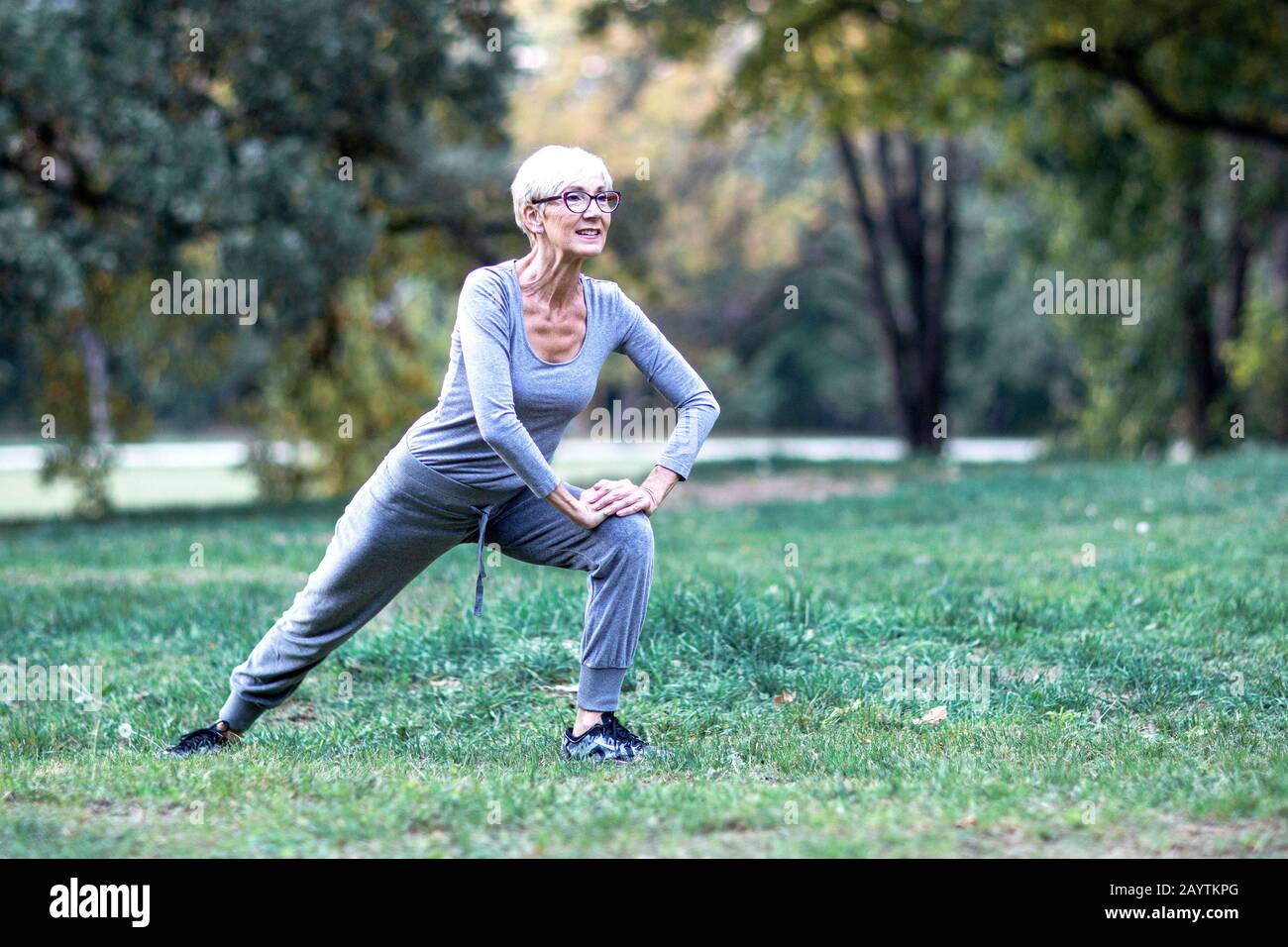 Elderly woman stretching park hi-res stock photography and images - Alamy