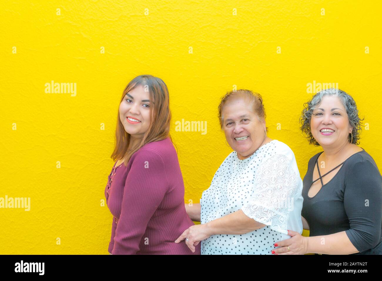 Granddaughter, grandmother and daughter taken from the waist very happy ...