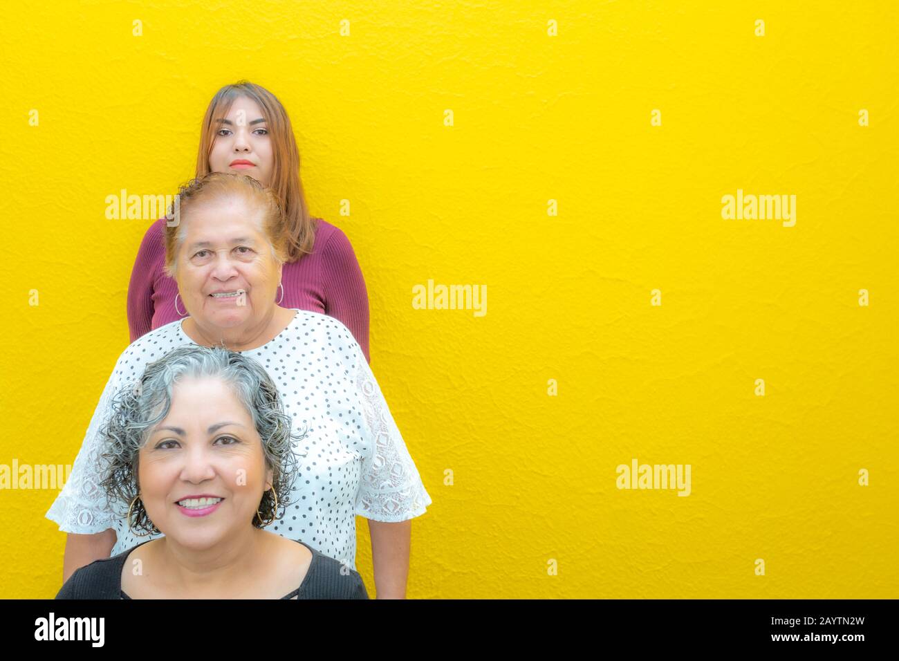 Three generations of latin Mexican women smiling in line, daughter ...
