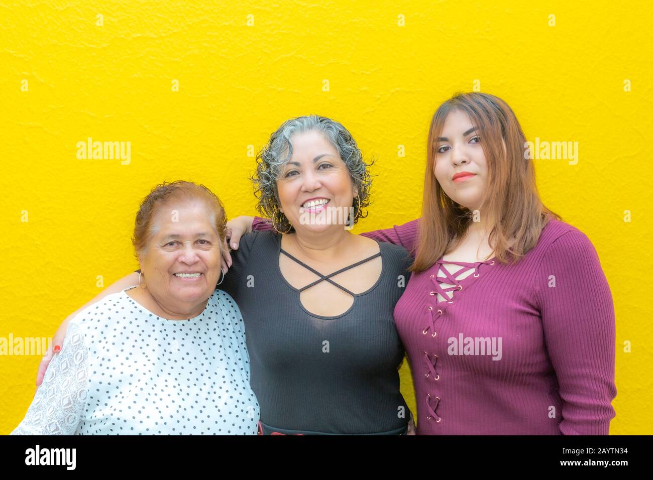 Three generations of latin Mexican women smiling, grandmother, daughter ...