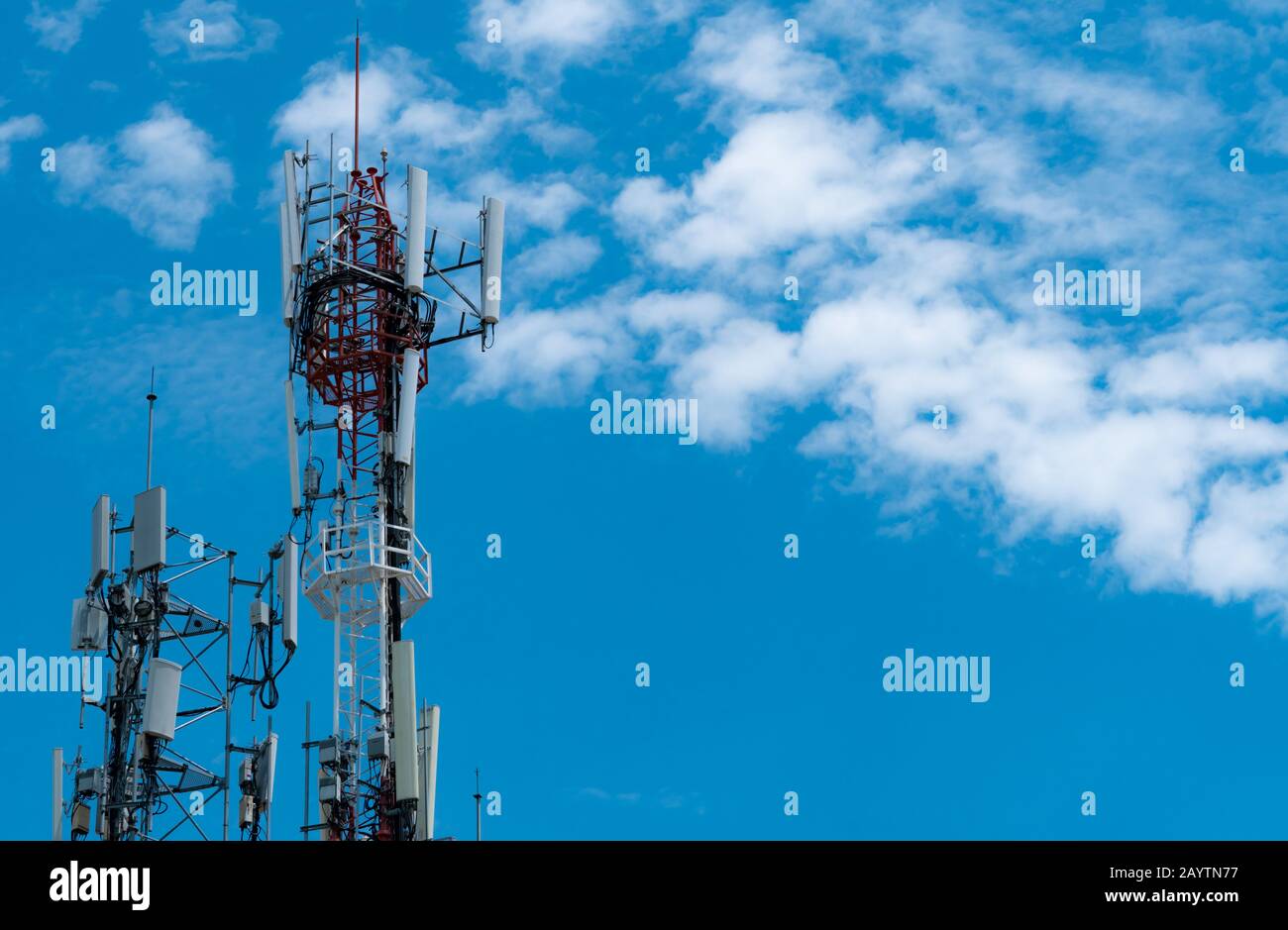 Telecommunication tower with blue sky and white clouds background ...