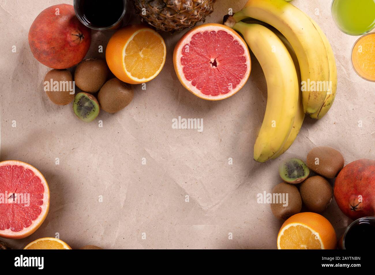 Fruit background .Mix of many fresh tropical fruits on grey background ...