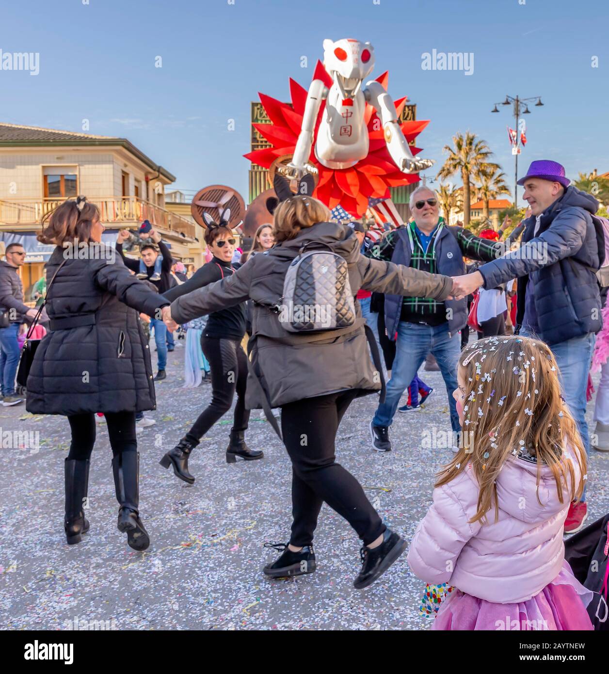 Blonde girl observes adults dancing in a circle with an allegorical ...