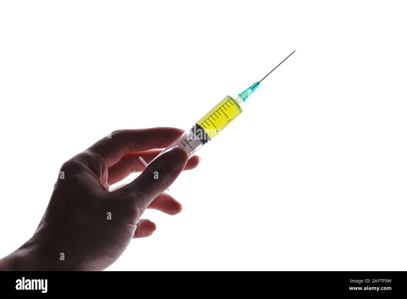 Syringe filled with bright green liquid being held in hand isolated on ...