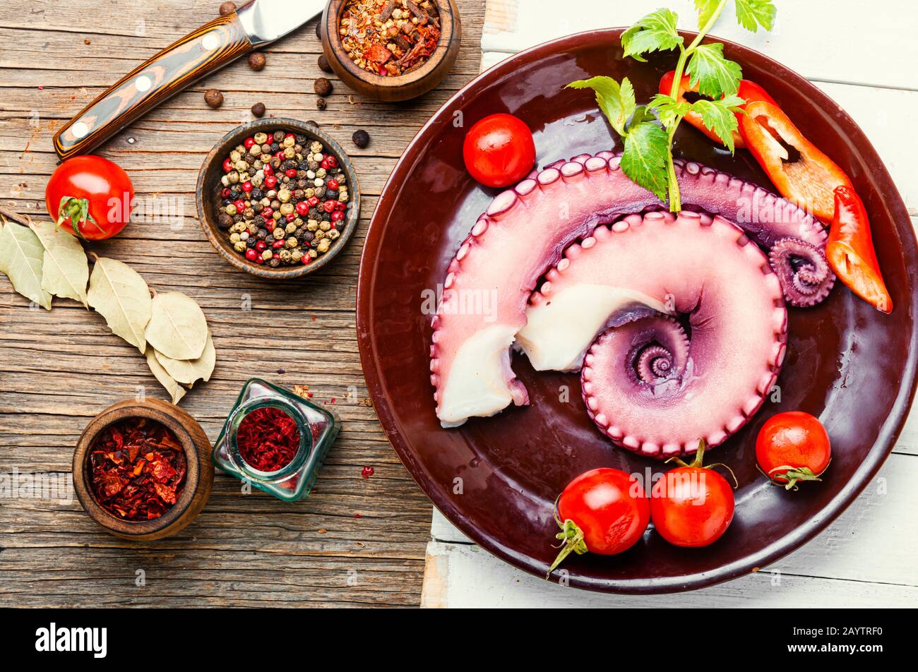 Fresh raw octopus and spice on plate.Uncooked octopus tentacles ...