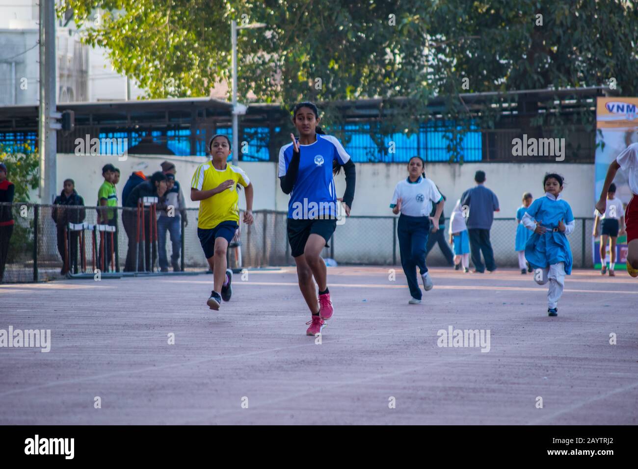 Girls running in 100 meter race compition Stock Photo - Alamy