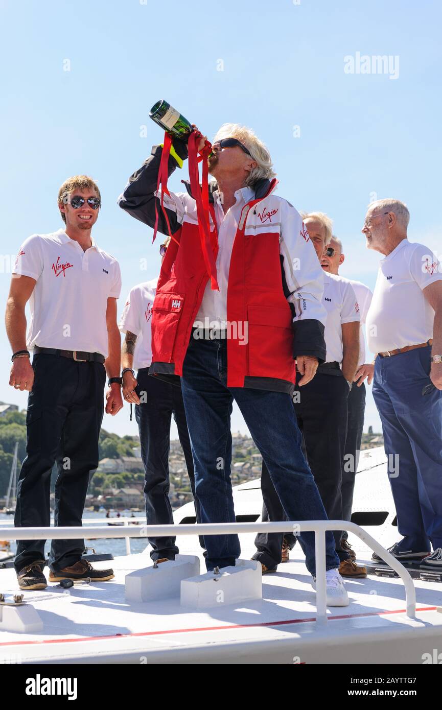 Sir Richard Branson pops champagne with the original and new crew of ...