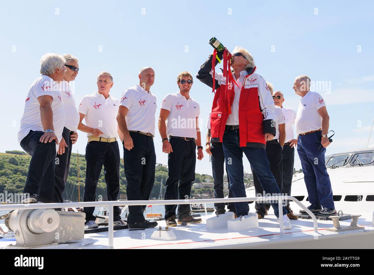 Sir Richard Branson pops champagne with the original and new crew of ...