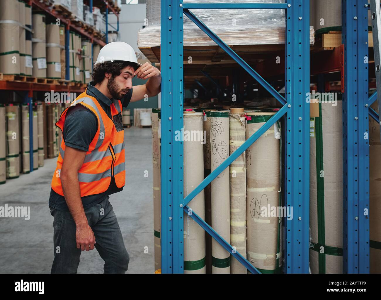 Stressed factory worker suffering head pain migraine or headache ...