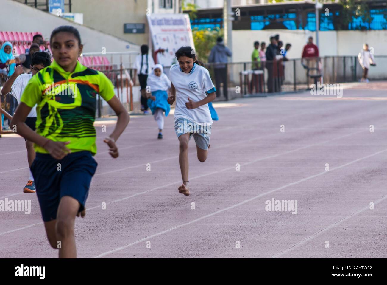 Girls running in 100 meter race compition Stock Photo - Alamy