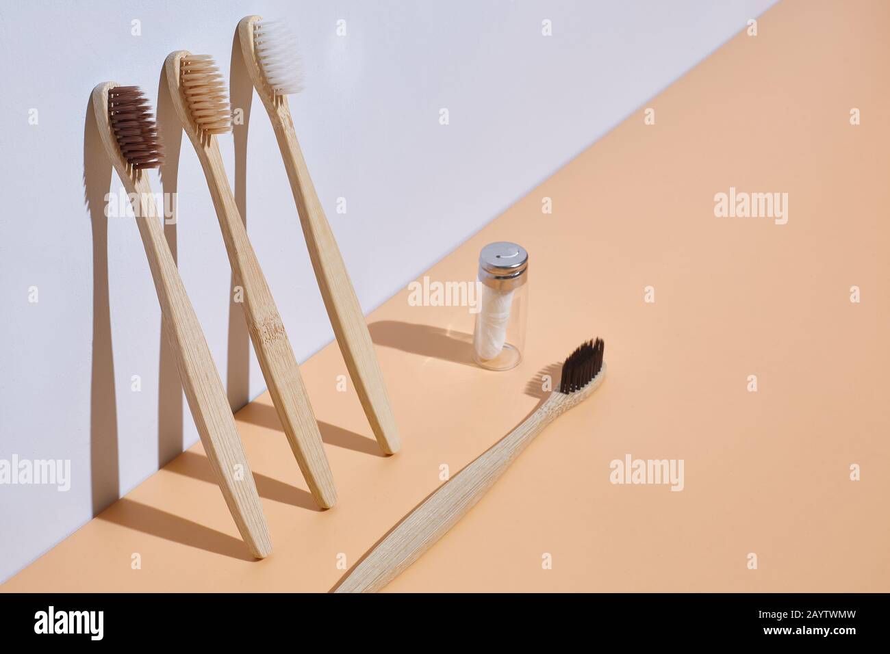 Wooden toothbrushes with dental floss. The concept of recycling garbage ...